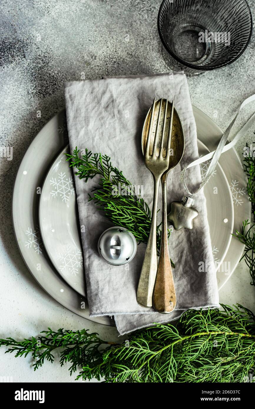 Empty plate with festive decor and cutlery on table fot Christmas ...