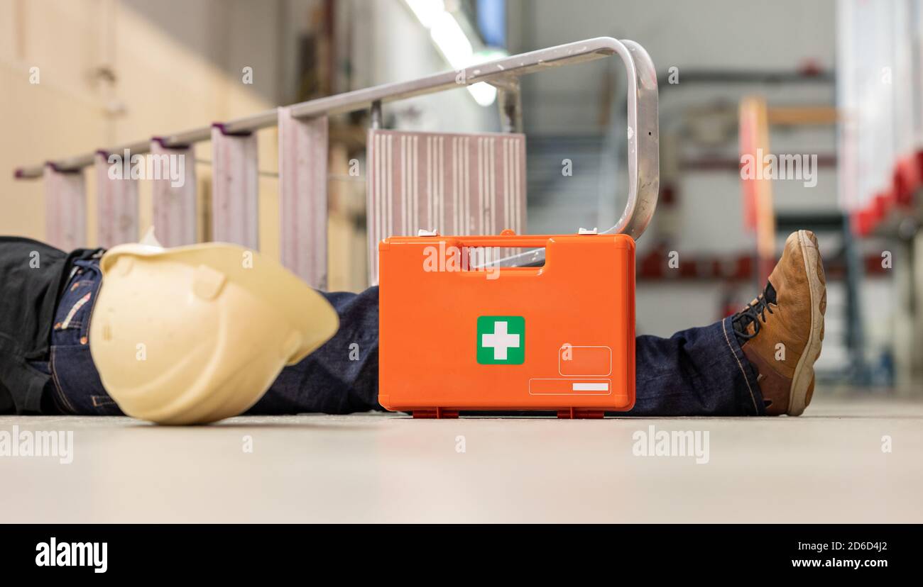 Male body lying on the floor after a work accident. Fallen ladder ...