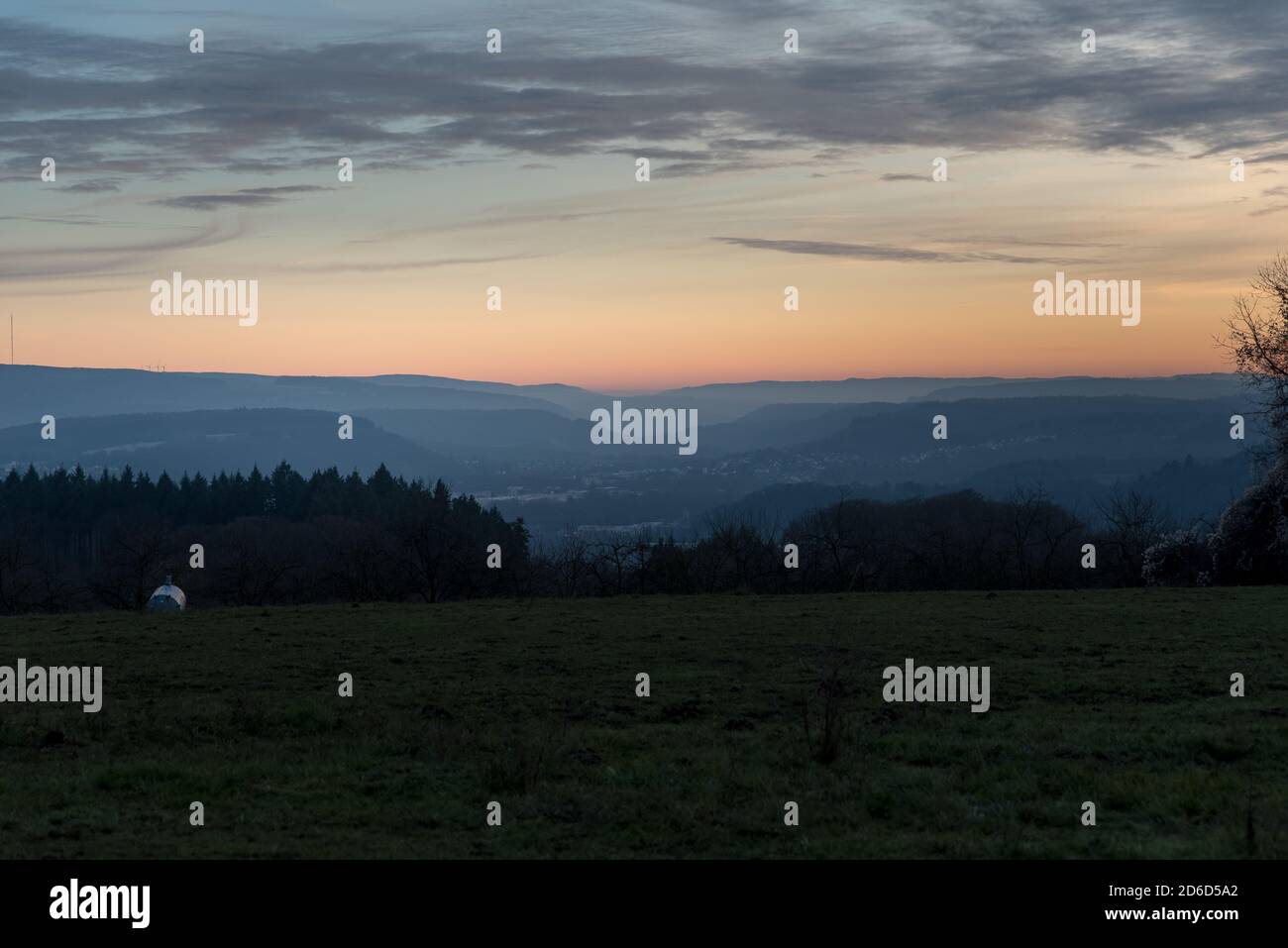uplands sunset sun below horizon trees and meadow Stock Photo - Alamy