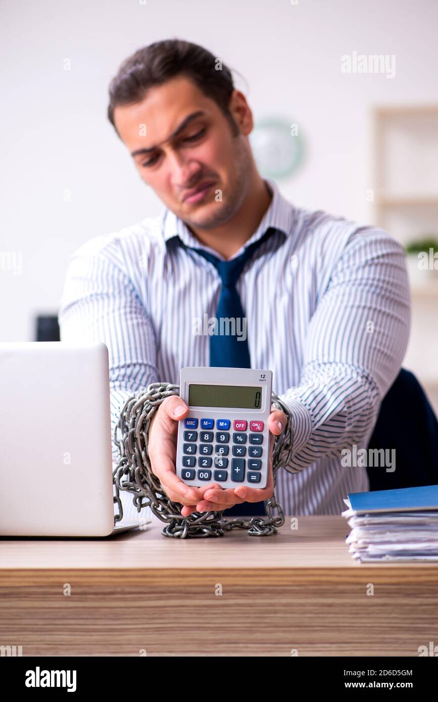 Chained employee working in the office Stock Photo - Alamy