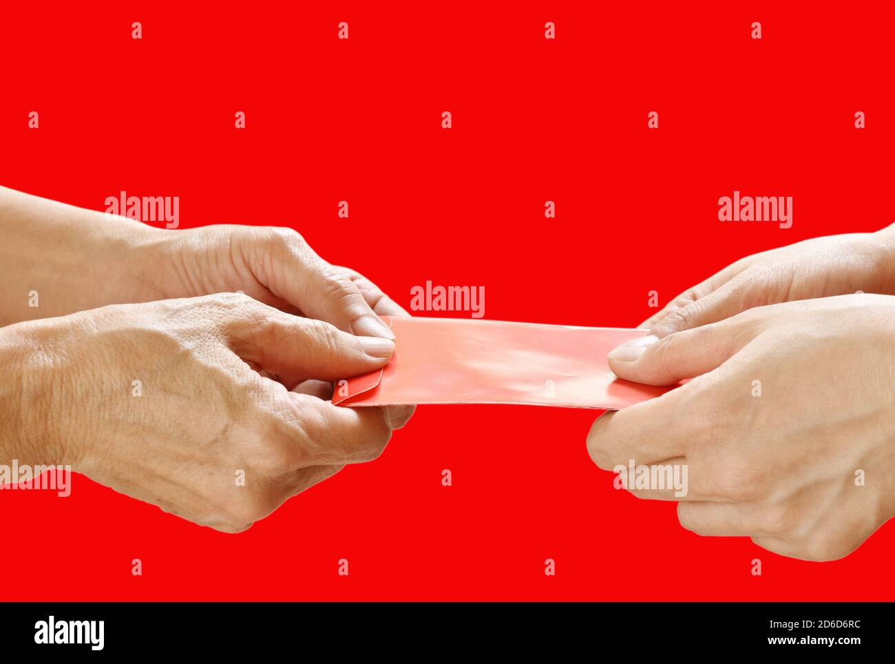 woman elder hand give red envelope for reward youth in Chinese new year ...