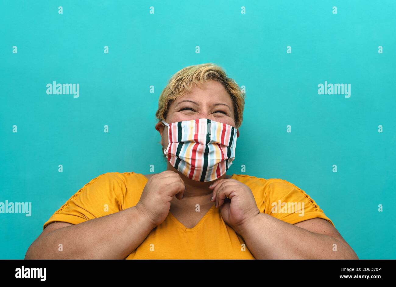 Happy plus size woman wearing face mask portrait - Curvy overweight ...