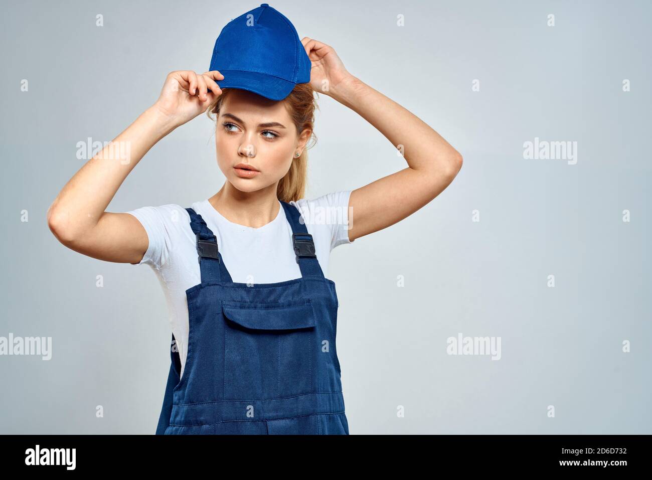 woman in work uniform blue cap service delivery service light ...