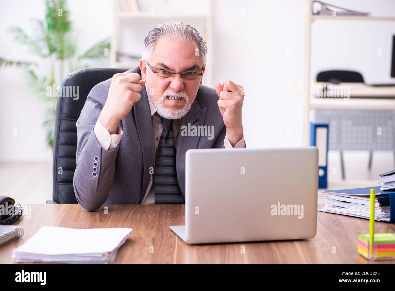 Businessman angry and furious at his workplace Stock Photo - Alamy