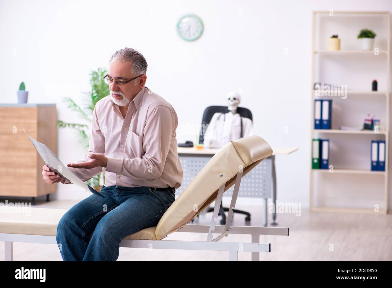 Skeleton doctor in funny medical concept Stock Photo - Alamy