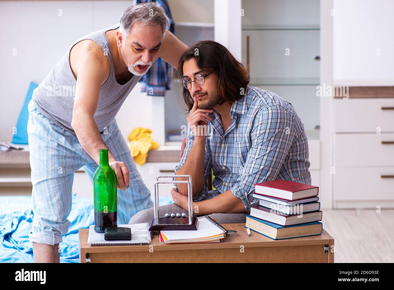 Young son student and dad alcoholic at home Stock Photo - Alamy