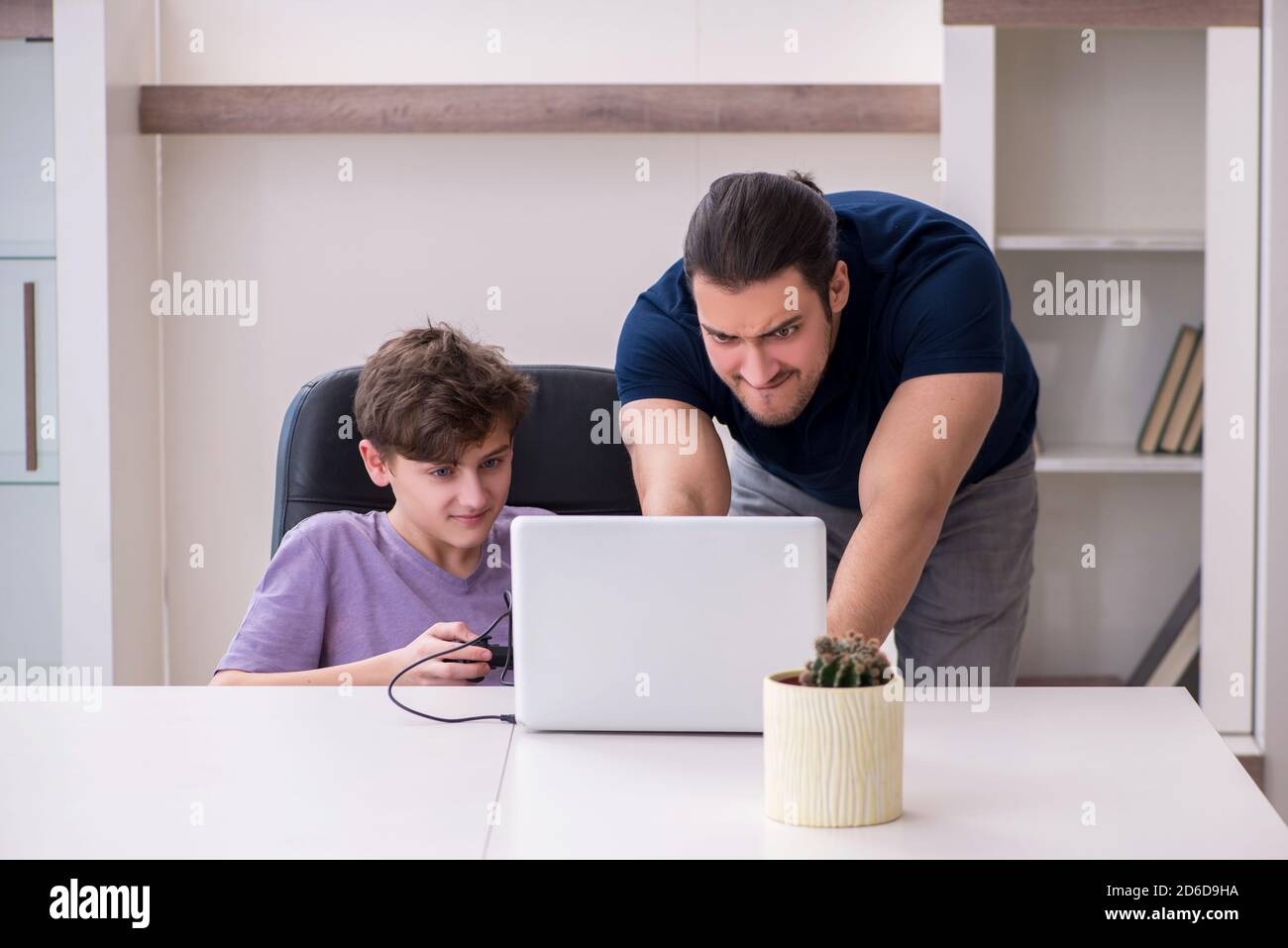 Father and schoolboy playing computer games at home Stock Photo - Alamy