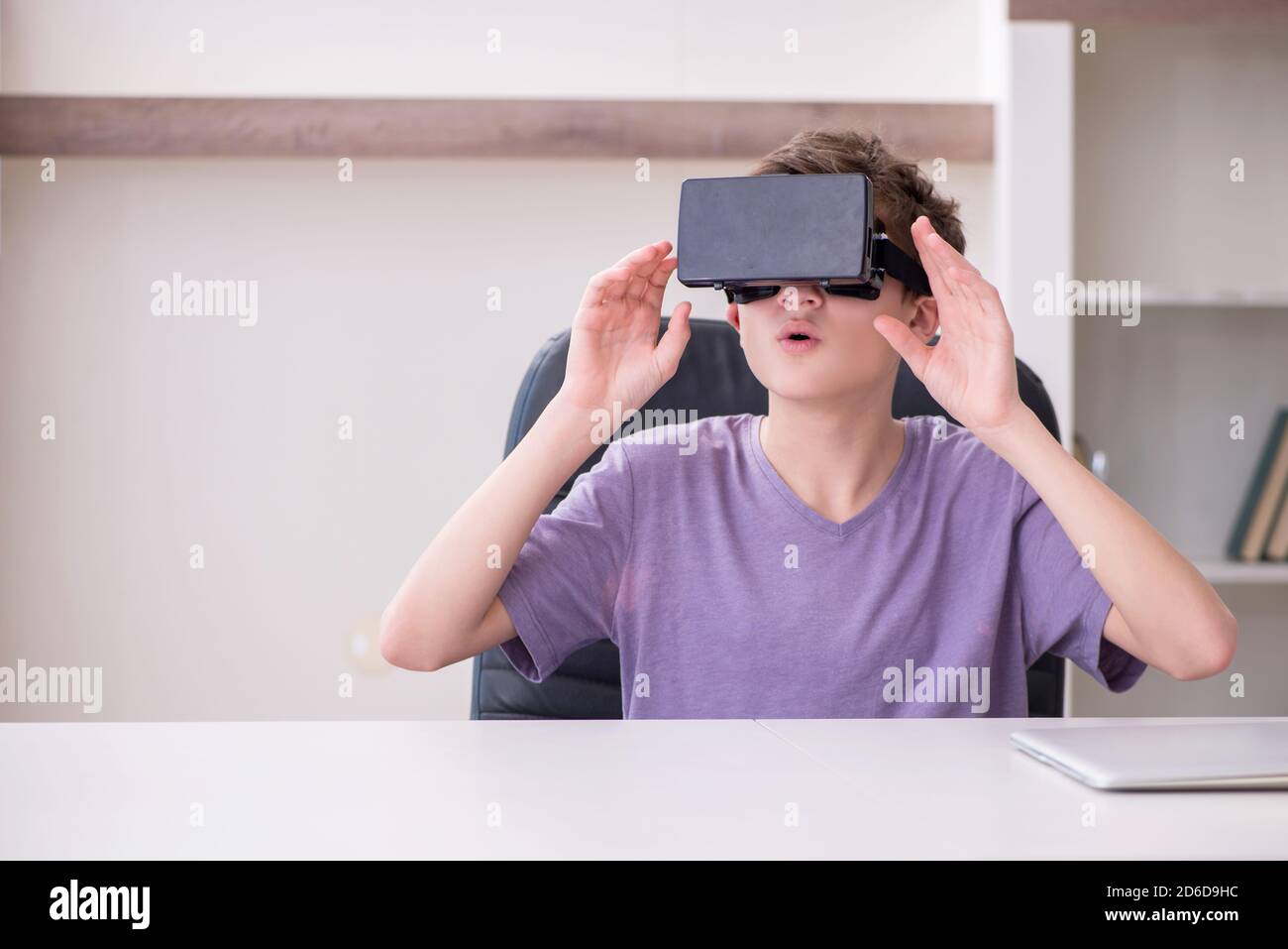 Boy wearing virtual glasses at home Stock Photo - Alamy