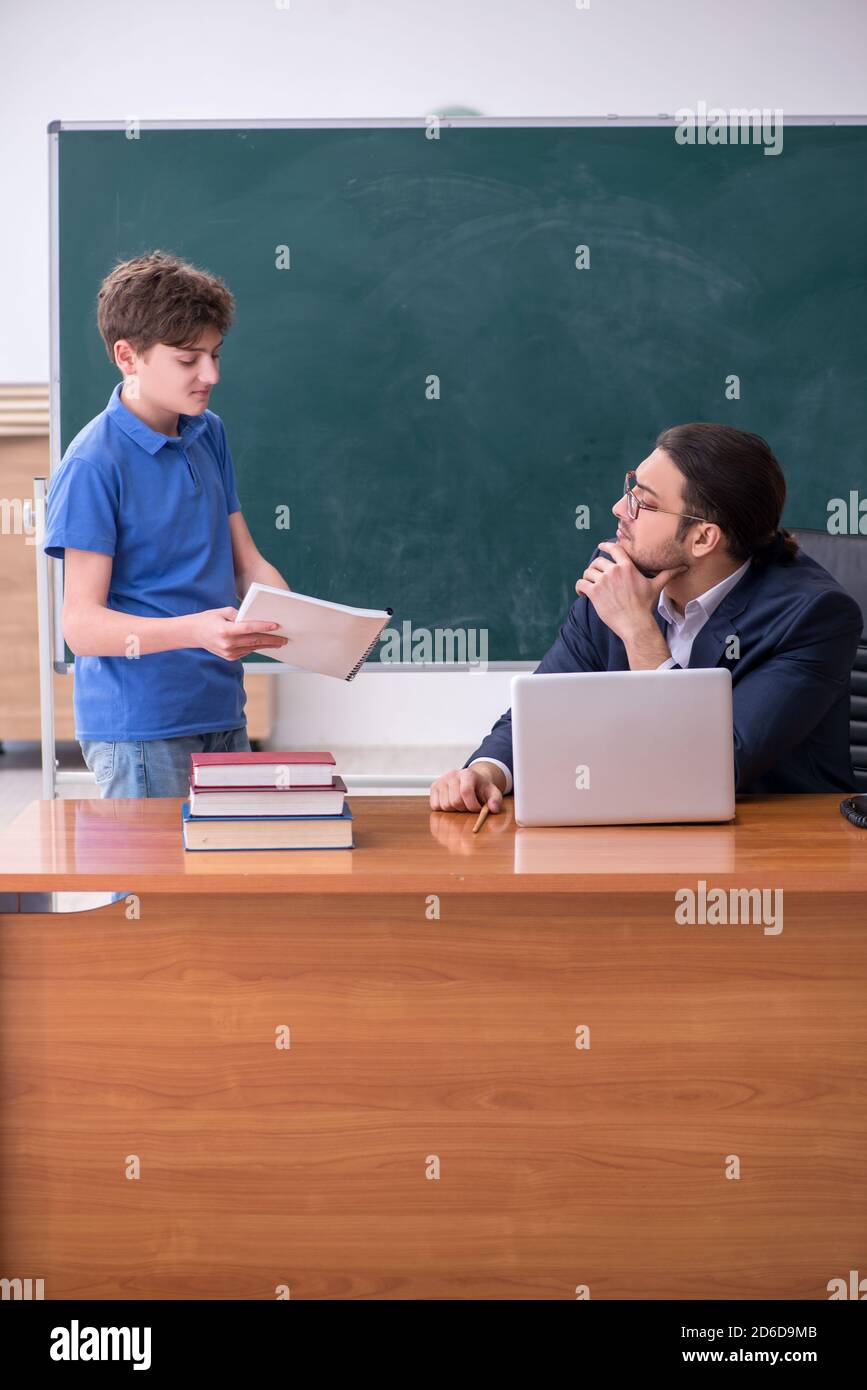 Male teacher and schoolboy in the classroom Stock Photo - Alamy