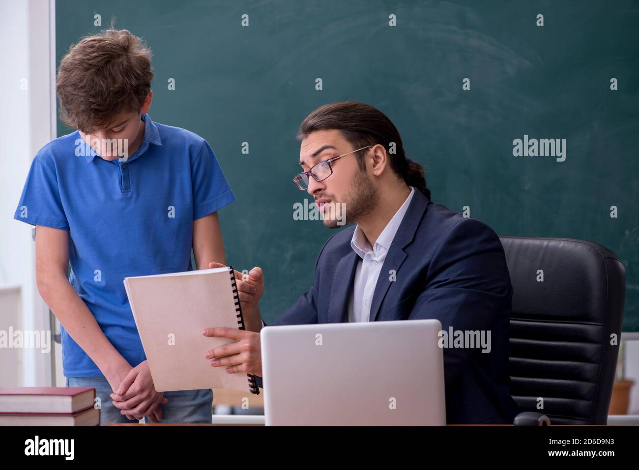 Male teacher and schoolboy in the classroom Stock Photo - Alamy