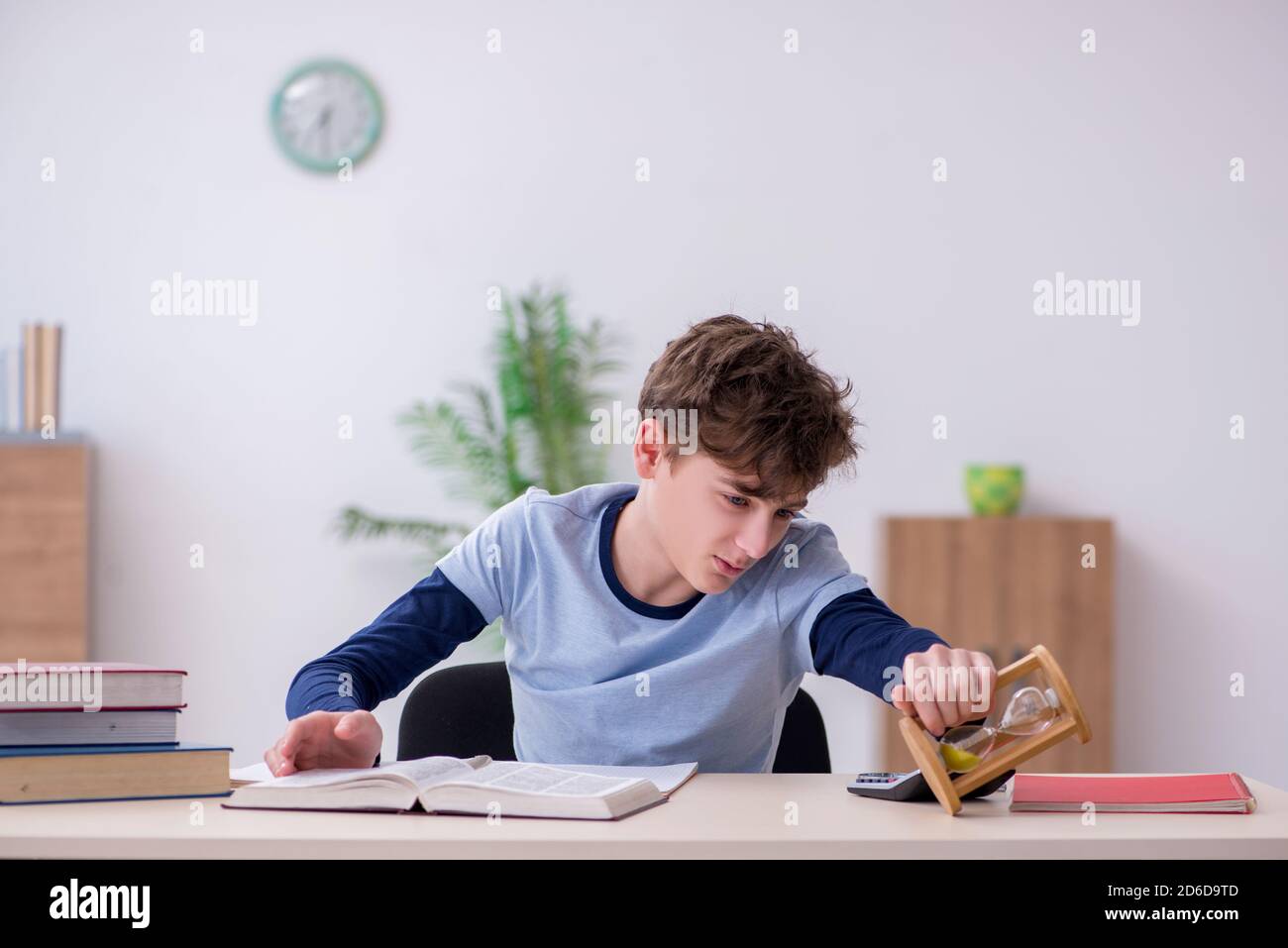 Boy preparing for exams in time management concept Stock Photo - Alamy