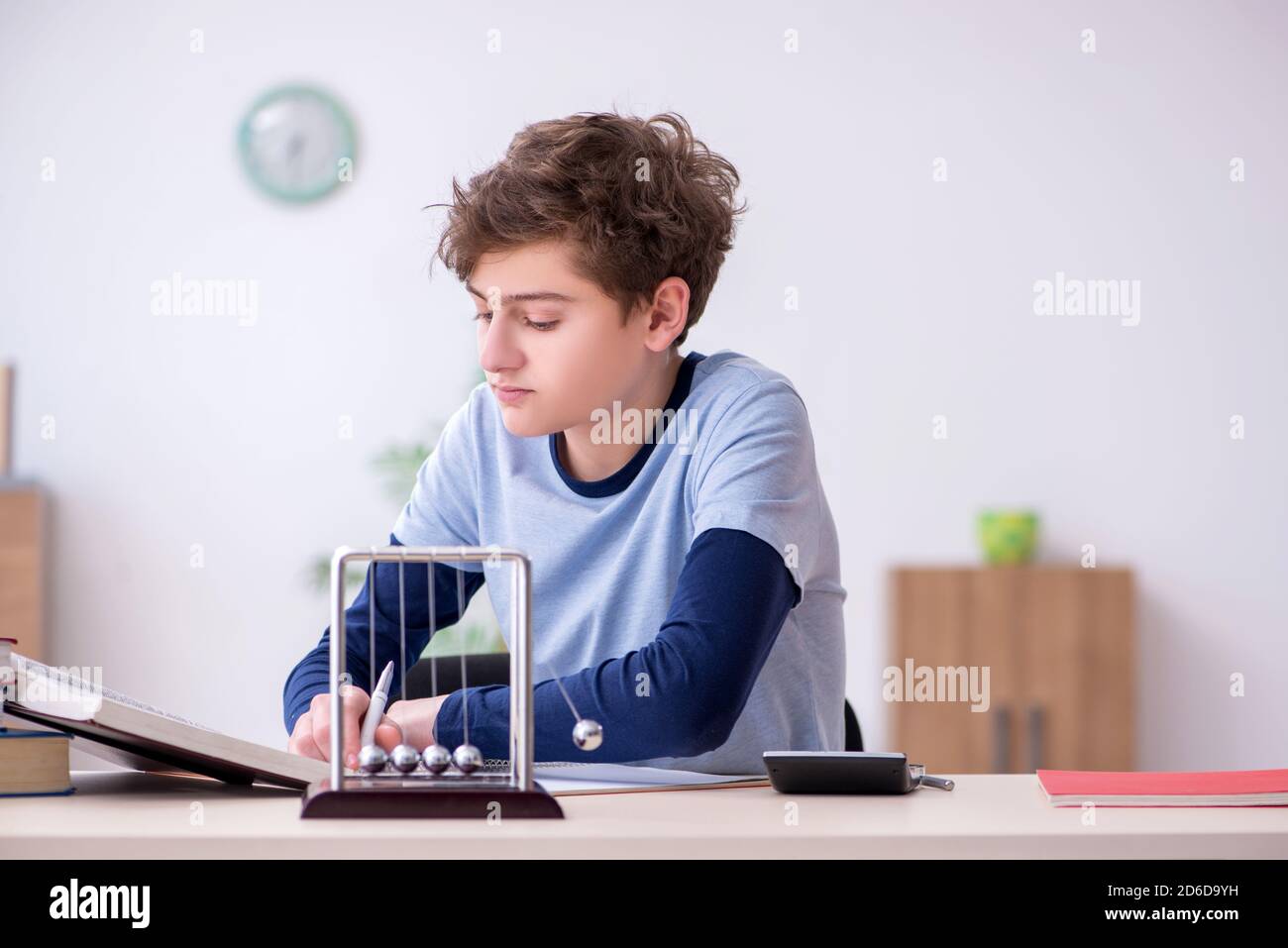 Boy studying physics at home Stock Photo - Alamy