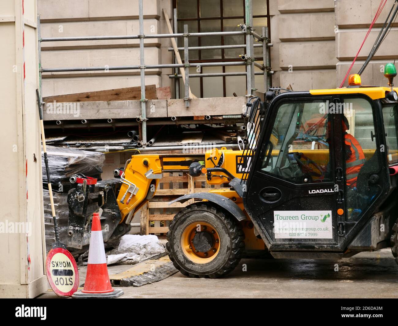 Forklift truck operator seen lifting building material Stock Photo - Alamy