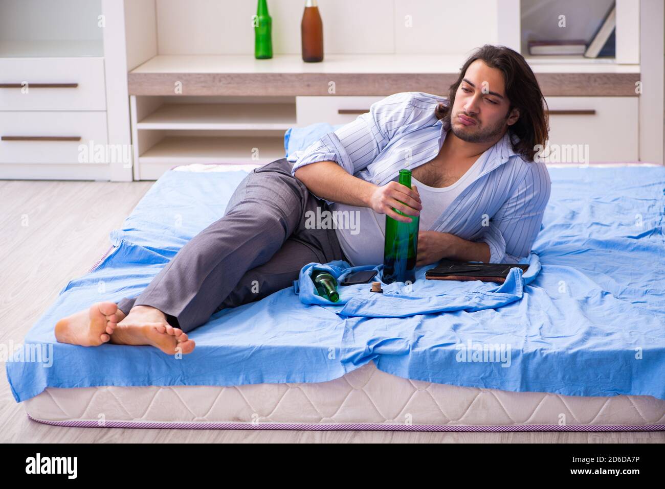 Male alcoholic in the bedroom Stock Photo - Alamy