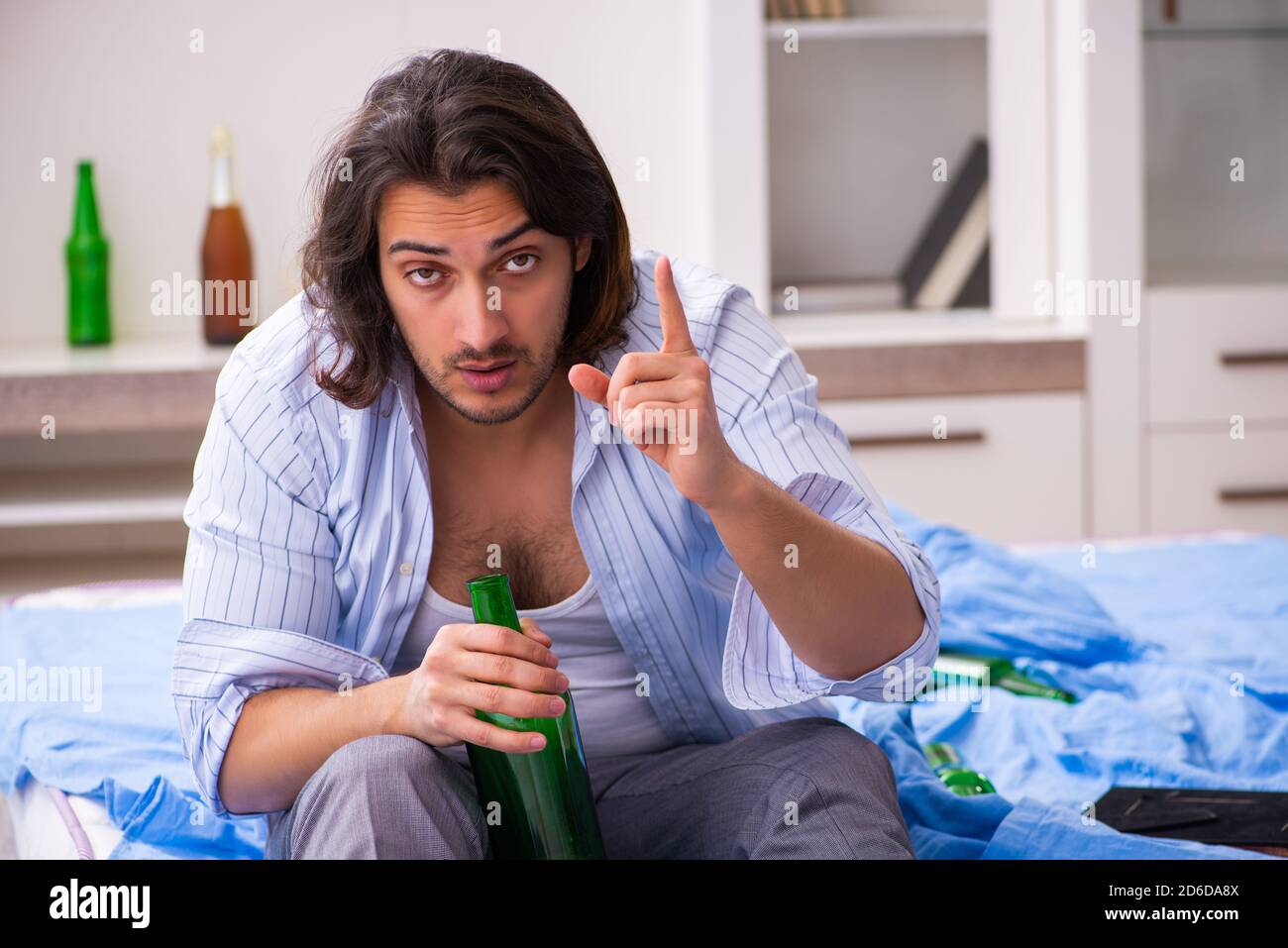 Male alcoholic in the bedroom Stock Photo - Alamy