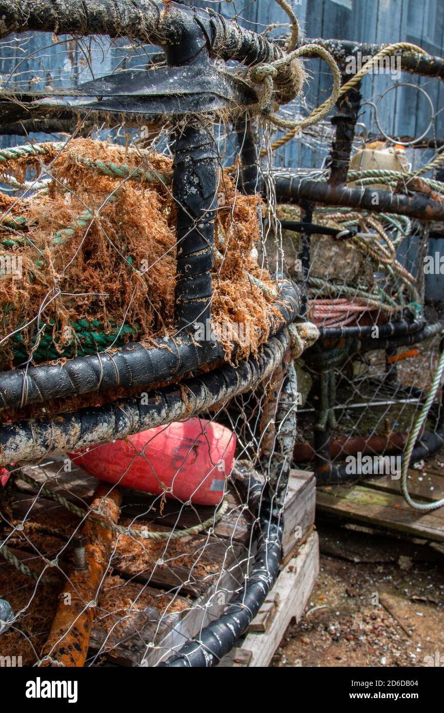 stack of rustic lobster and crab pots on a dock located in coastal ...