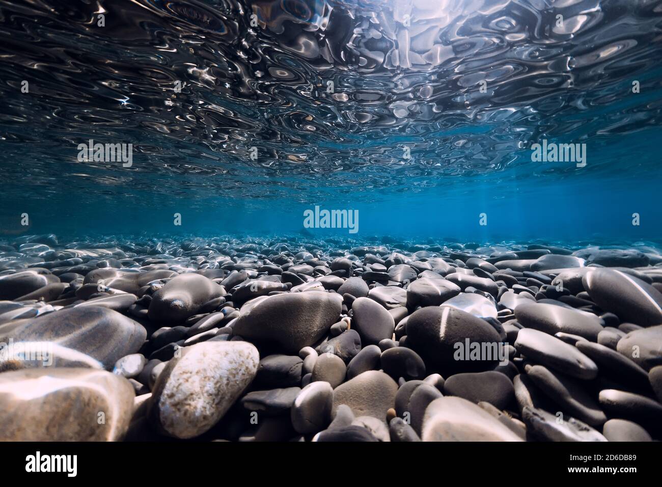 Underwater sea with stones, reflection and blue water. Ocean texture ...