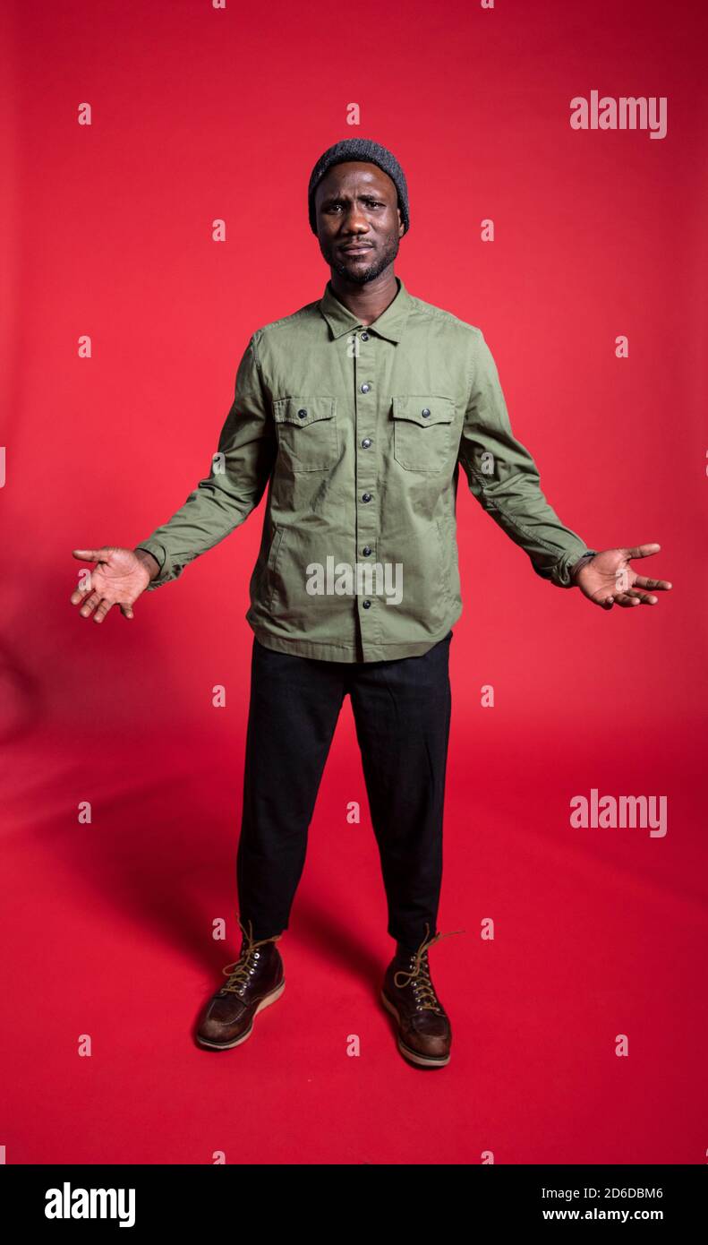 Young black man looking at camera with questioning body language. Full ...