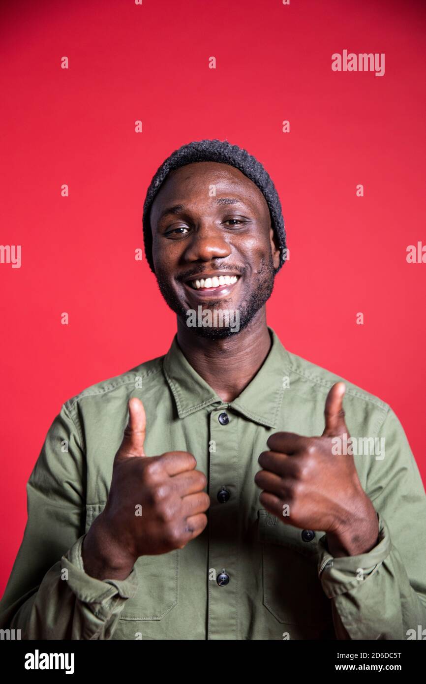 Young Black Man With Toothy Smile Giving Two Thumbs Up Isolated