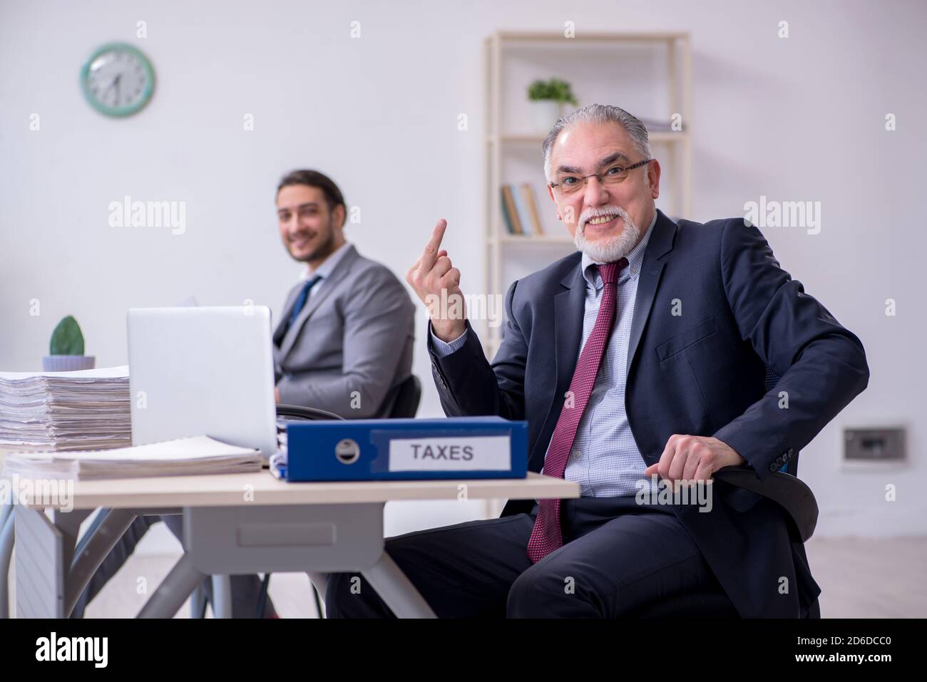Old boss and his assistant working in the office Stock Photo - Alamy