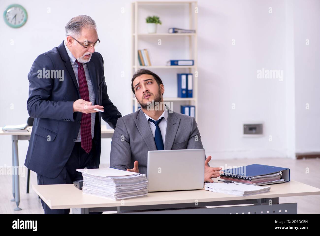 Old boss and his assistant working in the office Stock Photo - Alamy