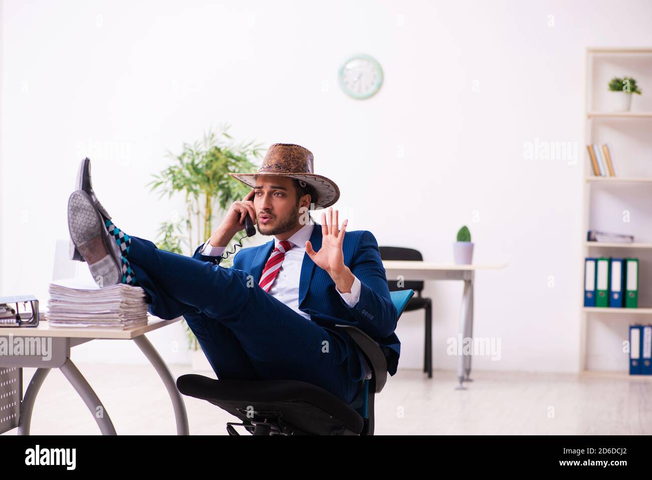 Businessman cowboy working in the office Stock Photo - Alamy