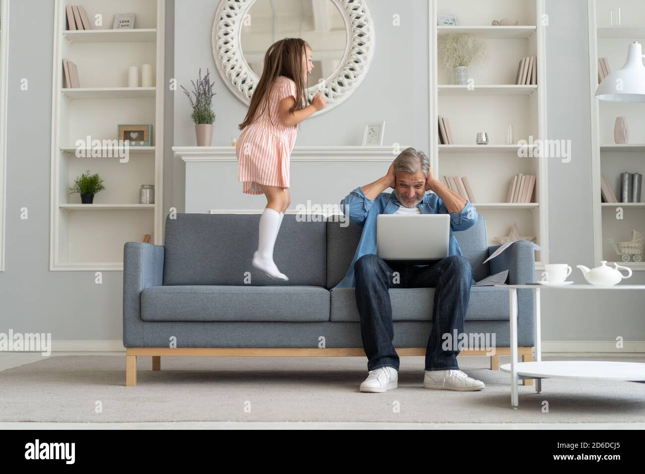 No Time For Child. Grey-haired dad busy with laptop, working online at ...