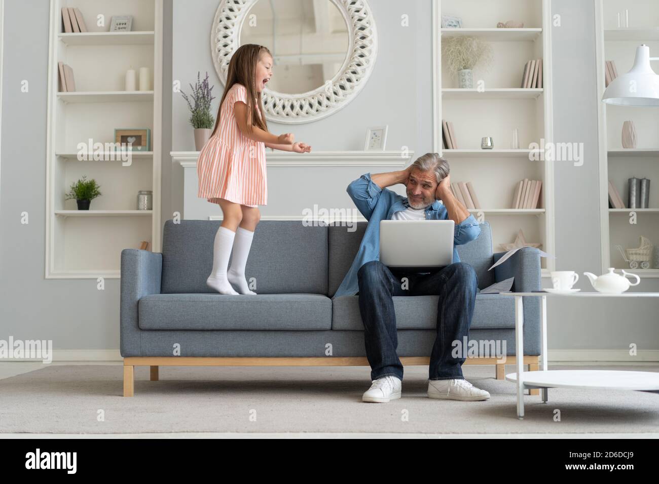 No Time For Child. Grey-haired dad busy with laptop, working online at ...