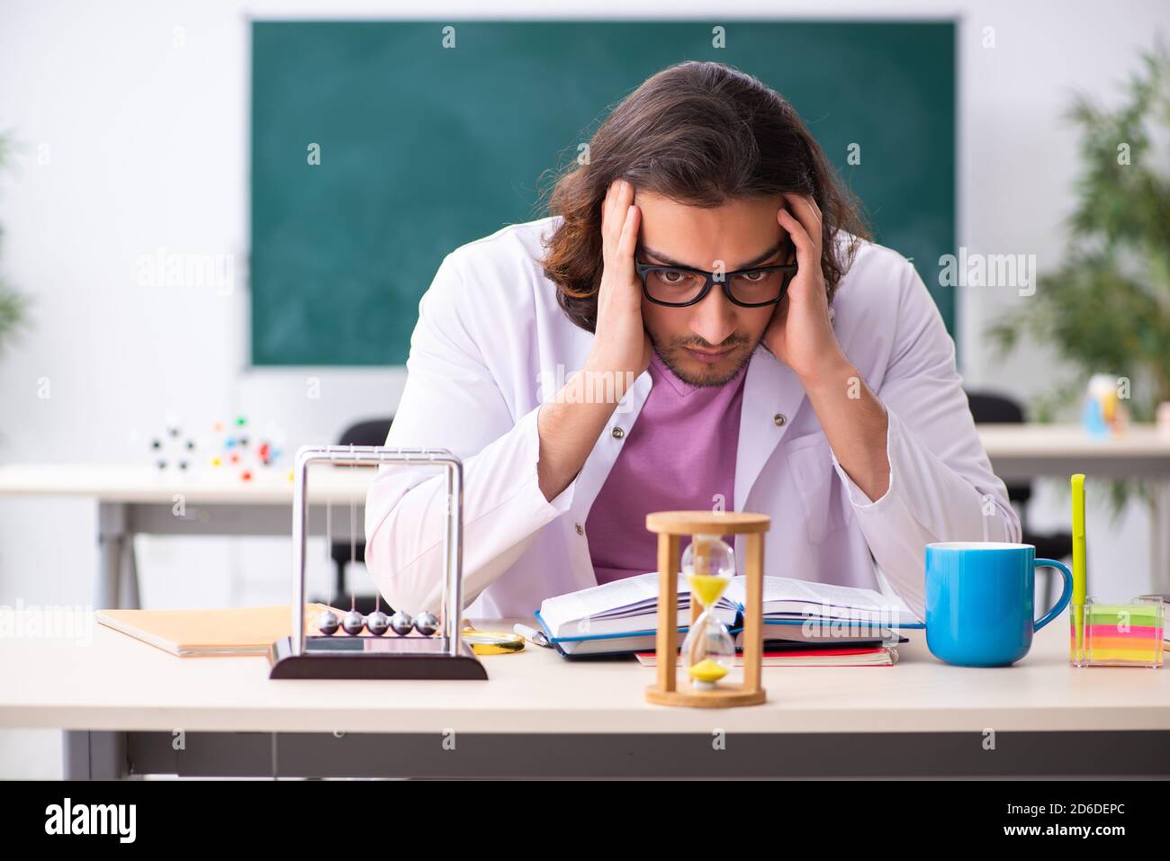 Young physicist teacher in time management concept Stock Photo - Alamy