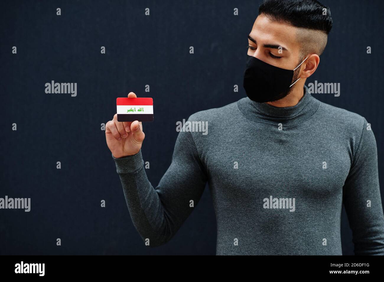 Middle eastern man in gray turtleneck and black face protect mask show ...