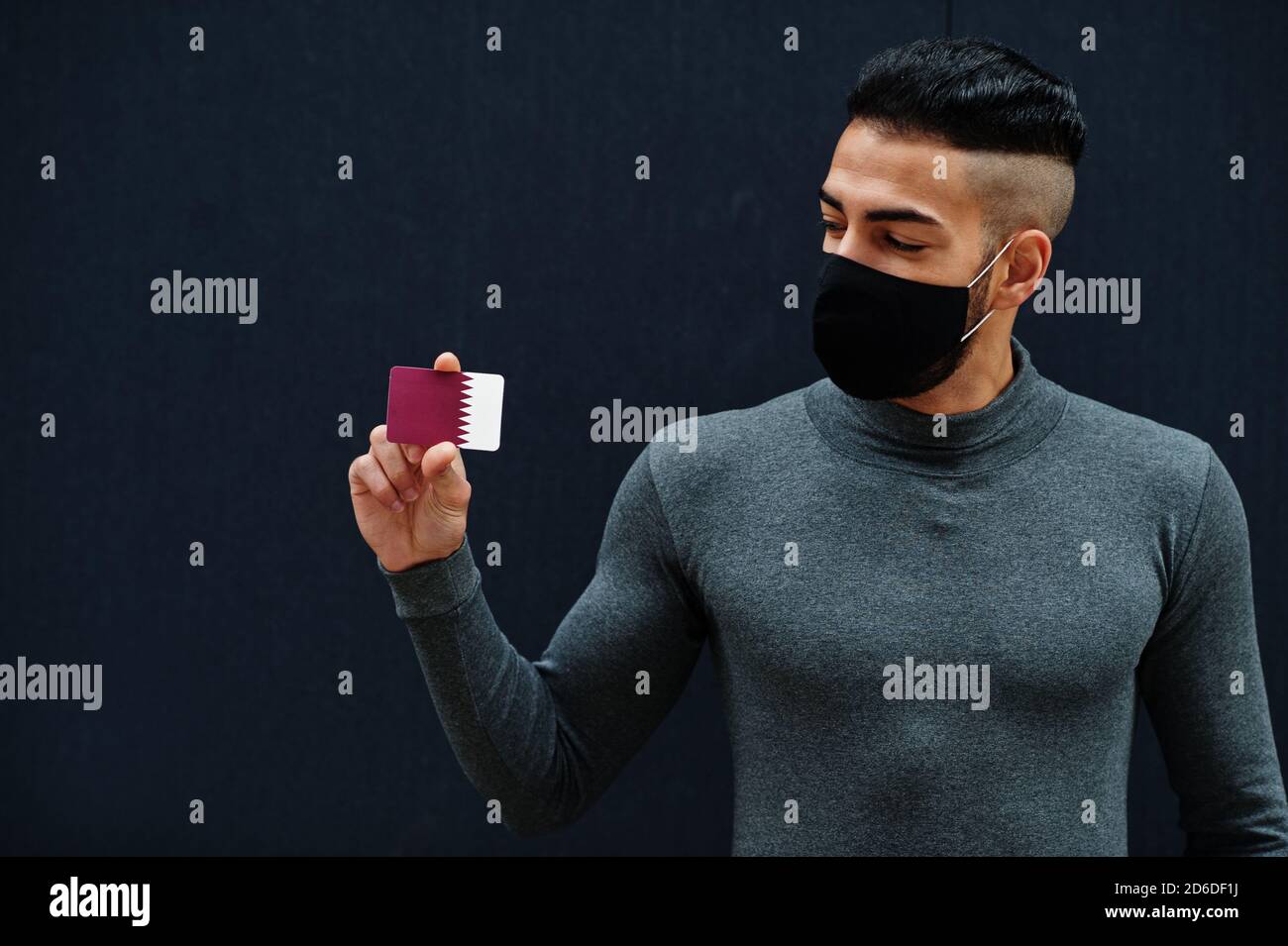 Middle eastern man in gray turtleneck and black face protect mask show ...