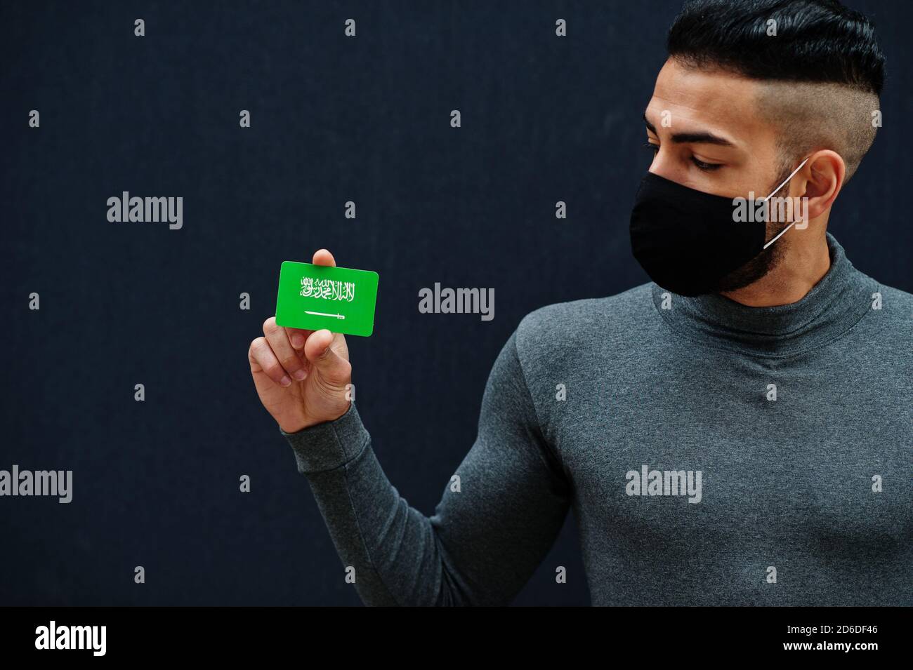 Middle eastern man in gray turtleneck and black face protect mask show ...