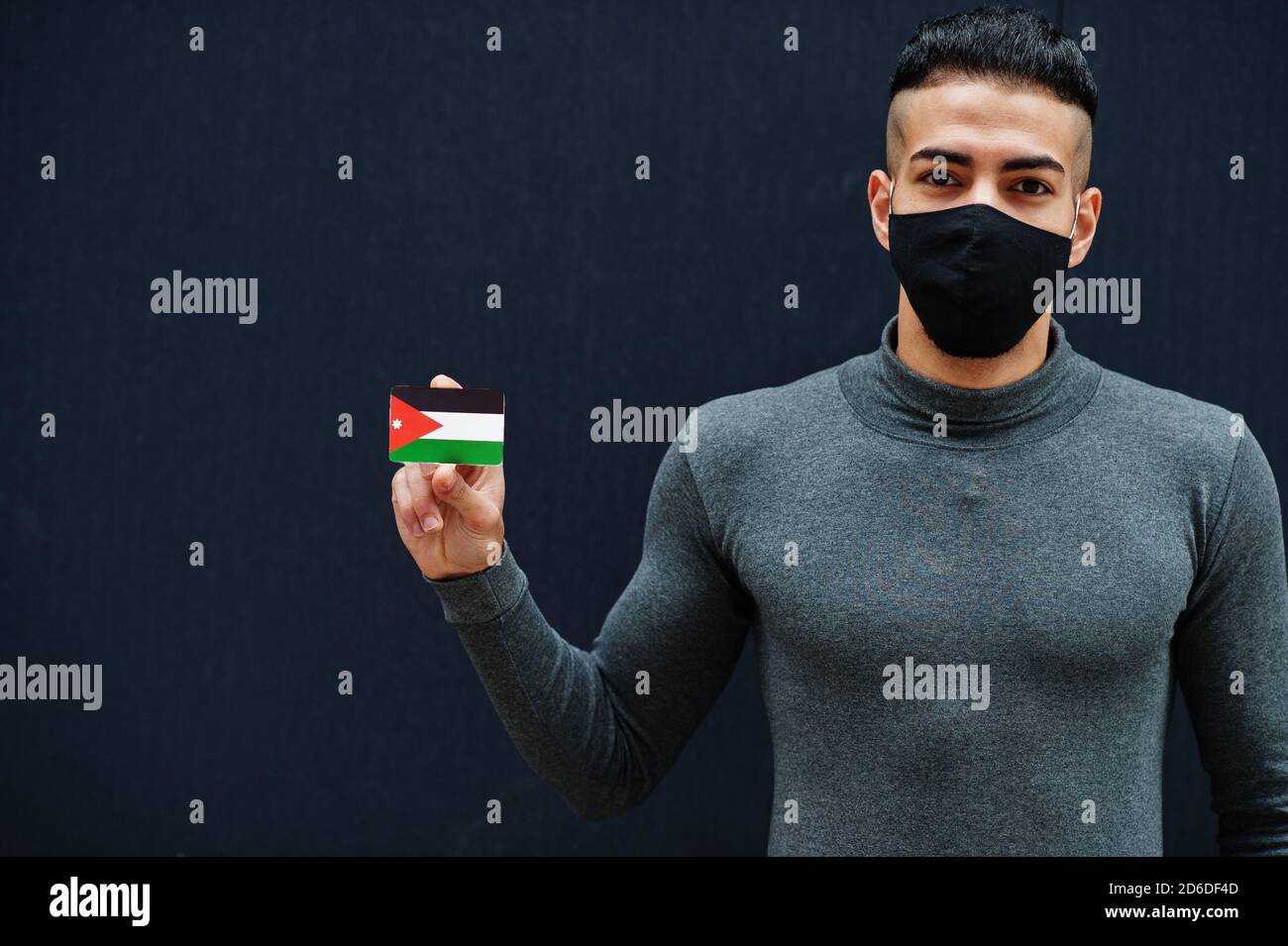 Middle eastern man in gray turtleneck and black face protect mask show ...
