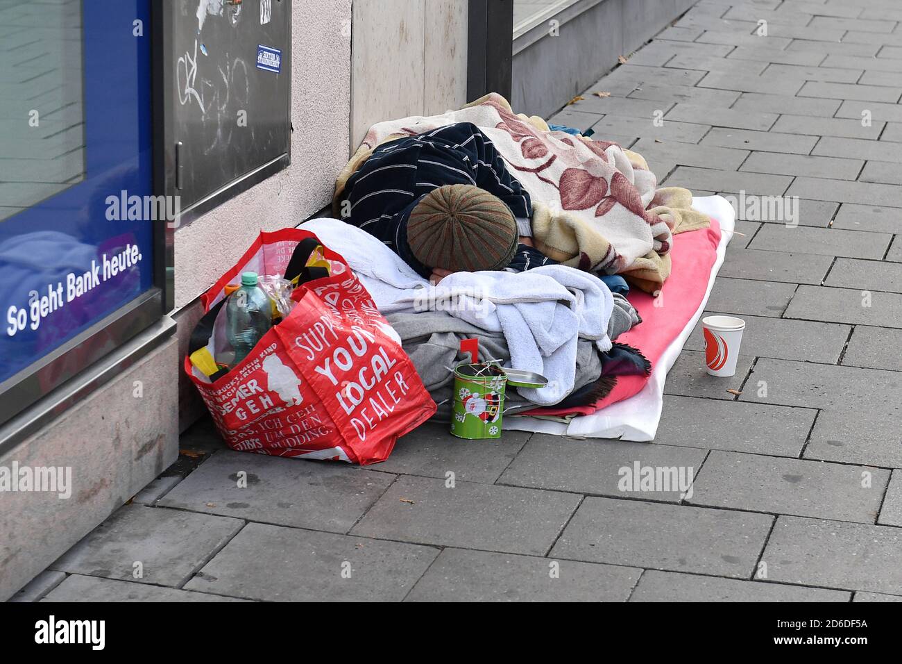 Munich, Deutschland. 19th Nov, 2019. Homeless man lies with his ...