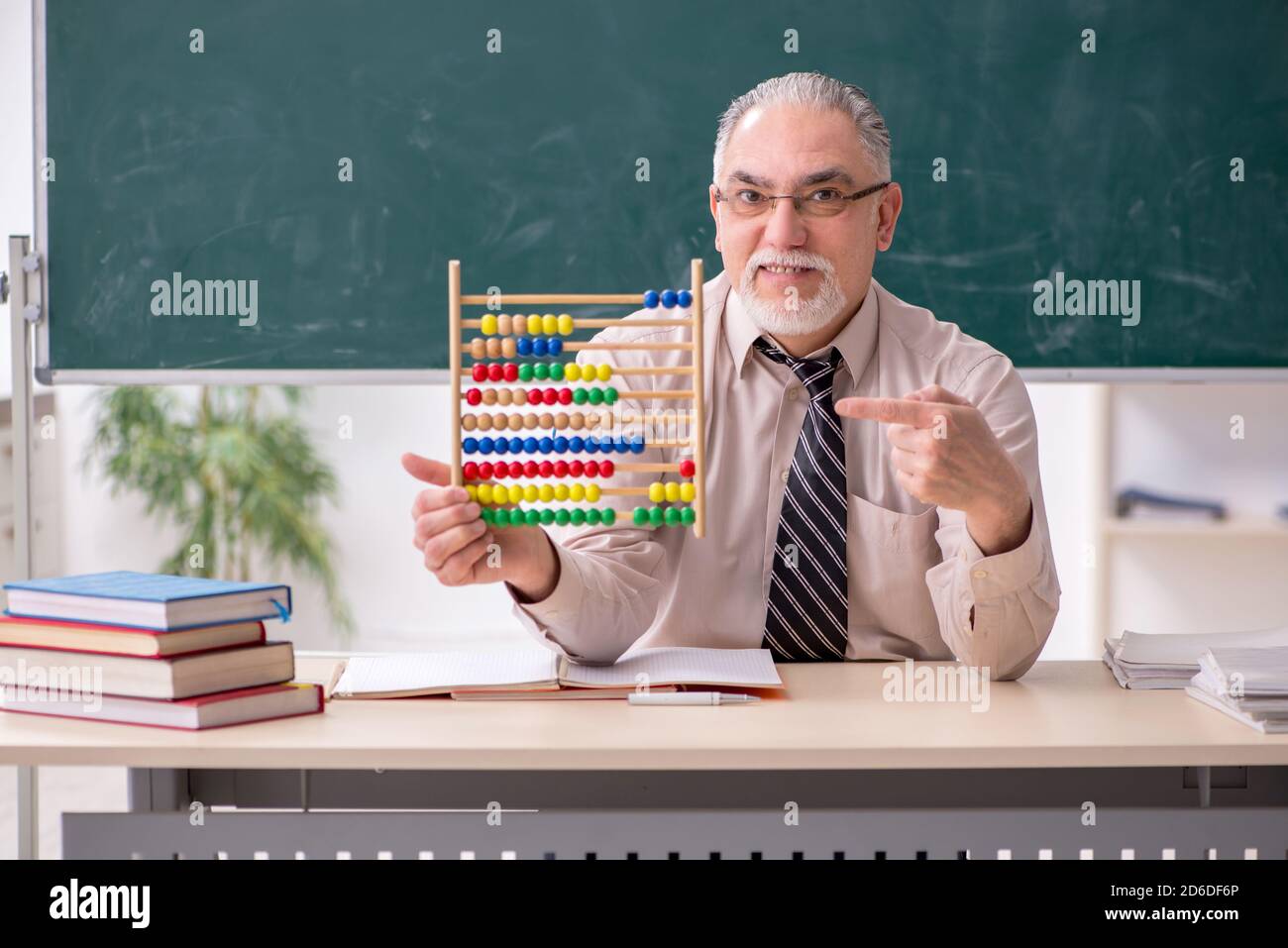 Old experienced teacher in the classroom Stock Photo - Alamy