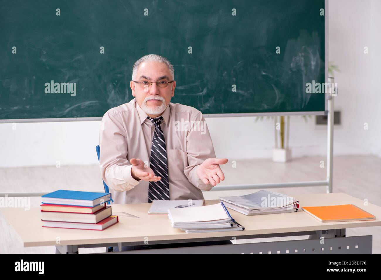 Old experienced teacher in the classroom Stock Photo - Alamy
