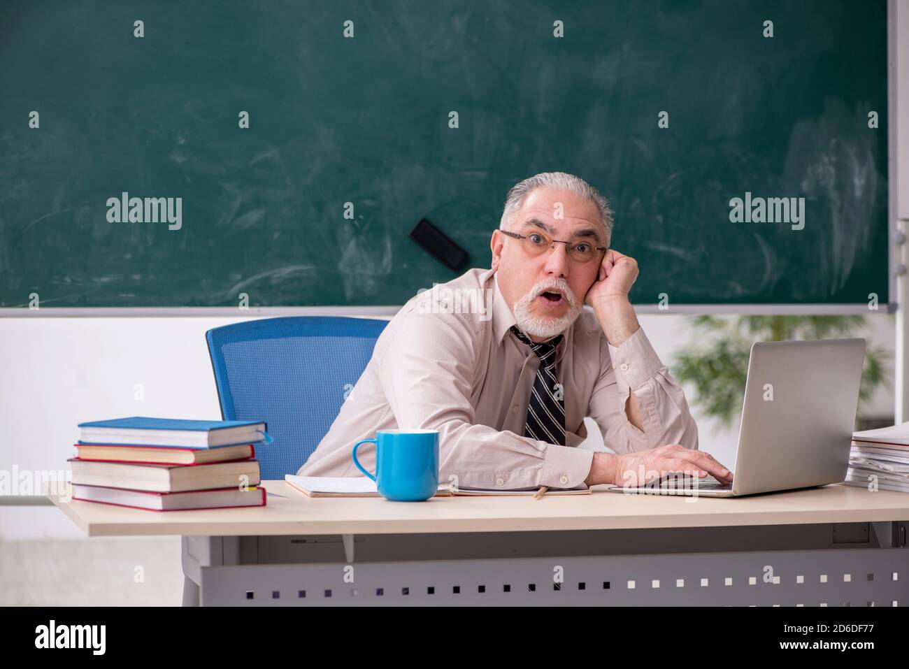 Old experienced teacher in the classroom Stock Photo - Alamy