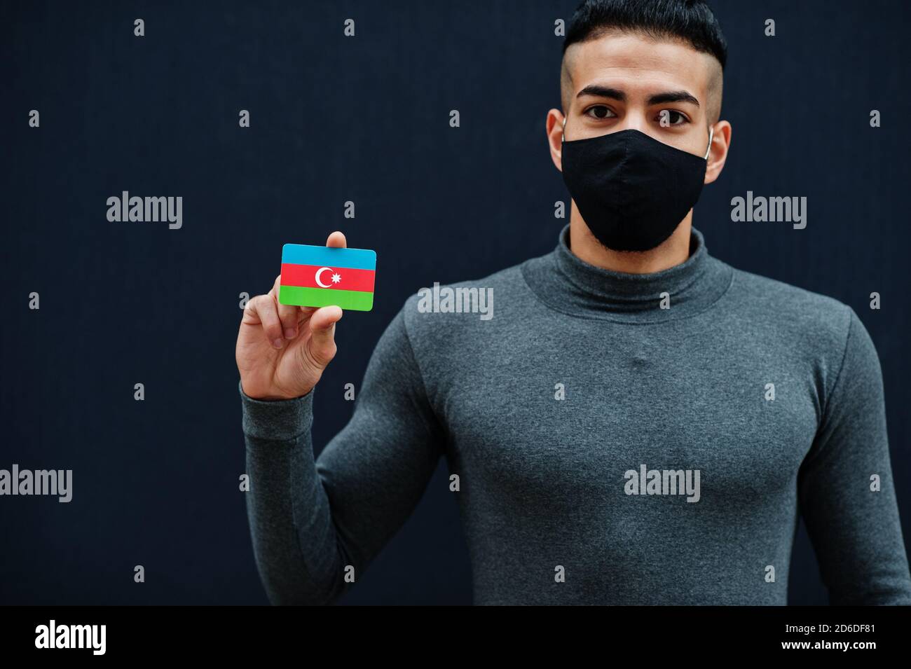 Middle eastern man in gray turtleneck and black face protect mask show ...