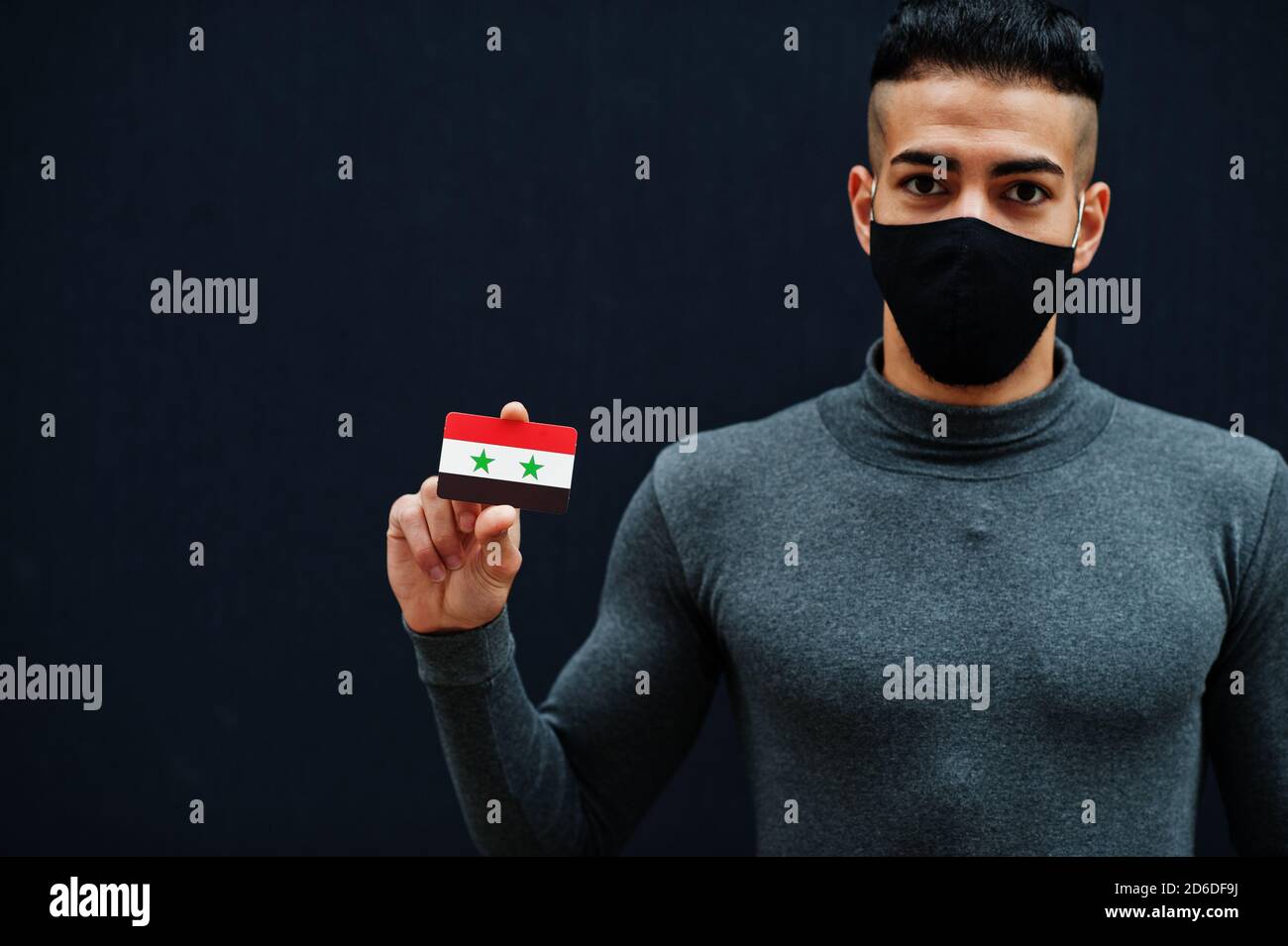 Middle eastern man in gray turtleneck and black face protect mask show ...
