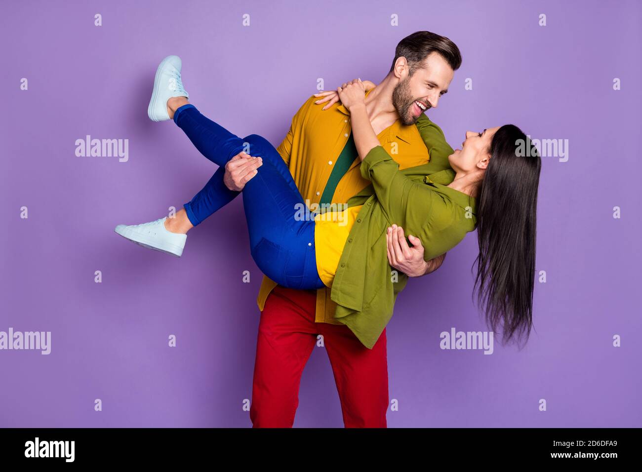 Photo pretty lady handsome fiance guy couple carry wife bride hold arms ...