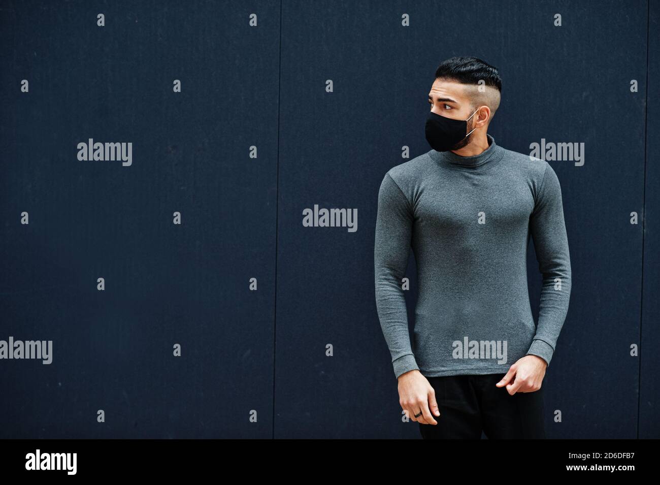 Middle eastern man in gray turtleneck and black face protect mask on ...