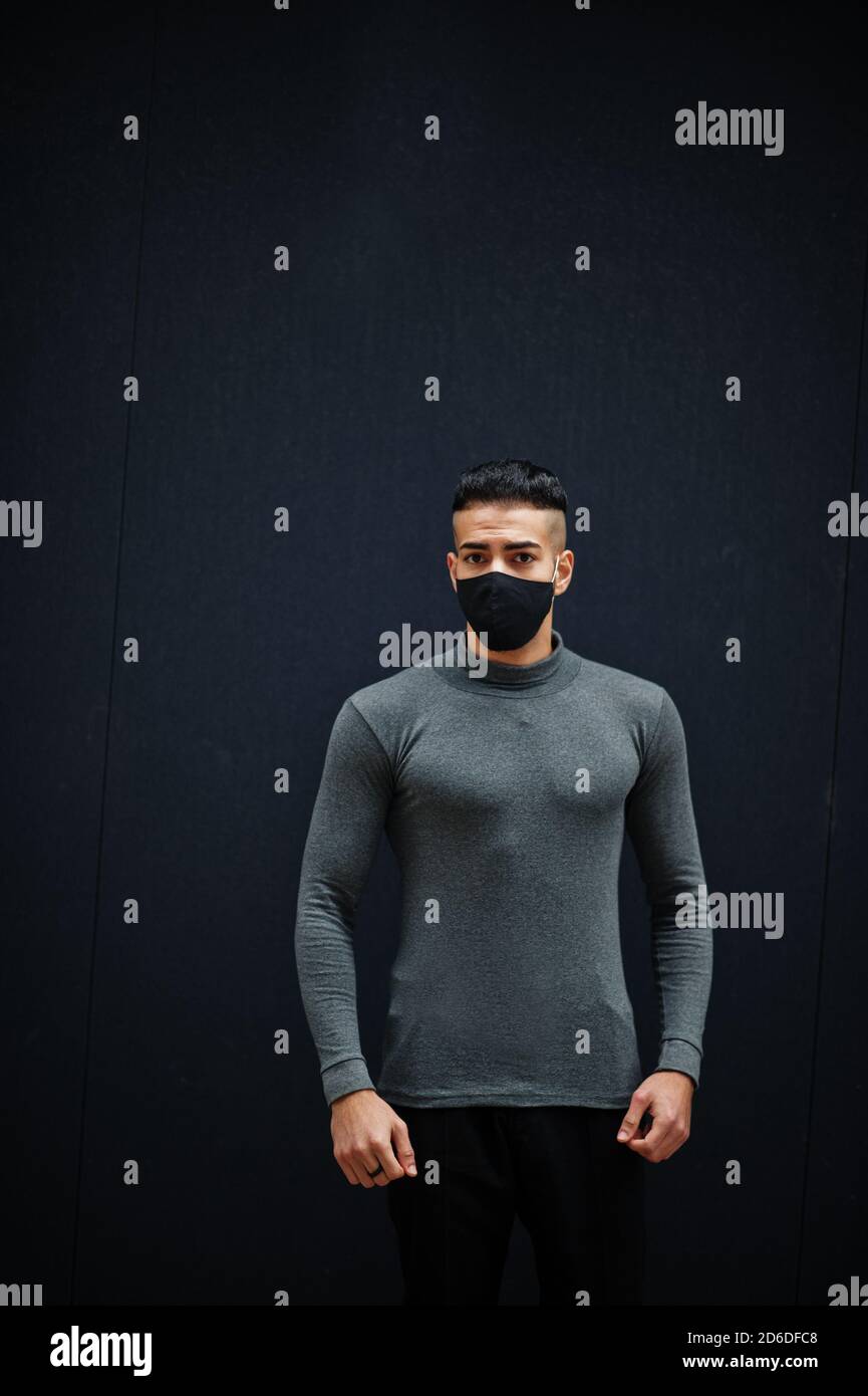 Middle eastern man in gray turtleneck and black face protect mask on ...