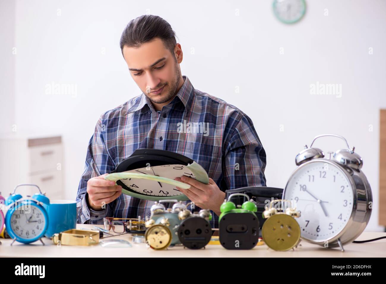 Young watchmaker working in the workshop Stock Photo - Alamy