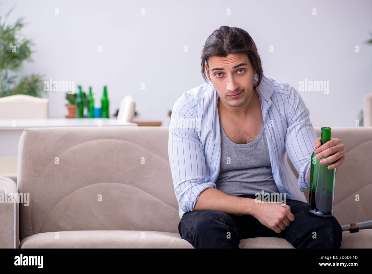Male alcoholic drinking wine at home Stock Photo - Alamy