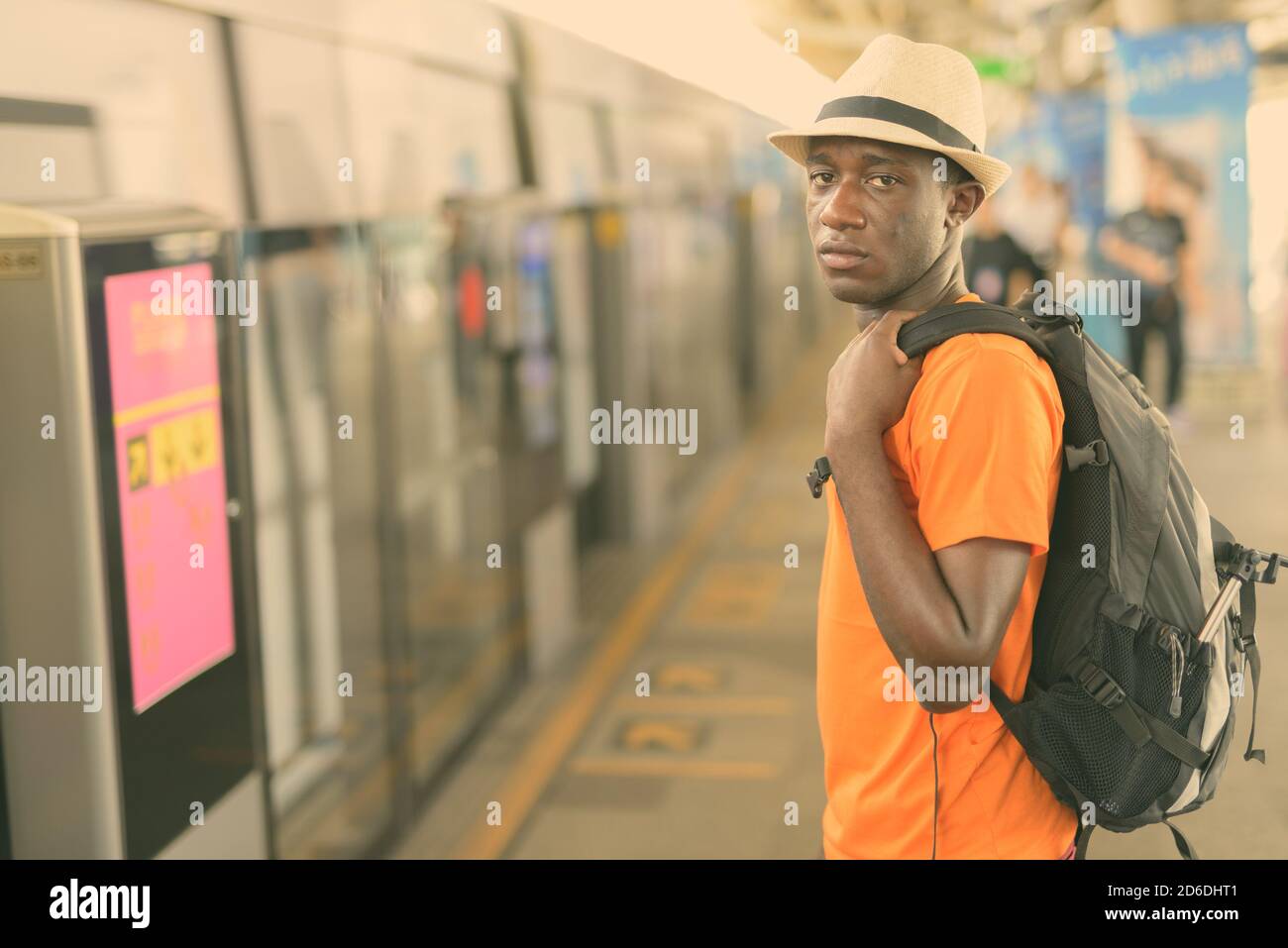 Young black African tourist man waiting for the train at BTS sky train ...