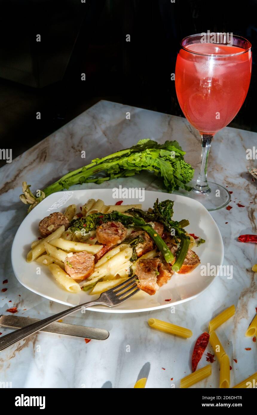 Italian spicy sausage penne pasta and broccoli rabe with dramatic ...