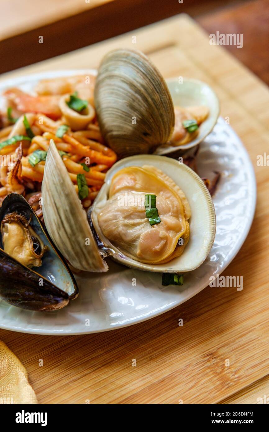 Italian seafood pasta pescatore with clams mussels and squid Stock ...