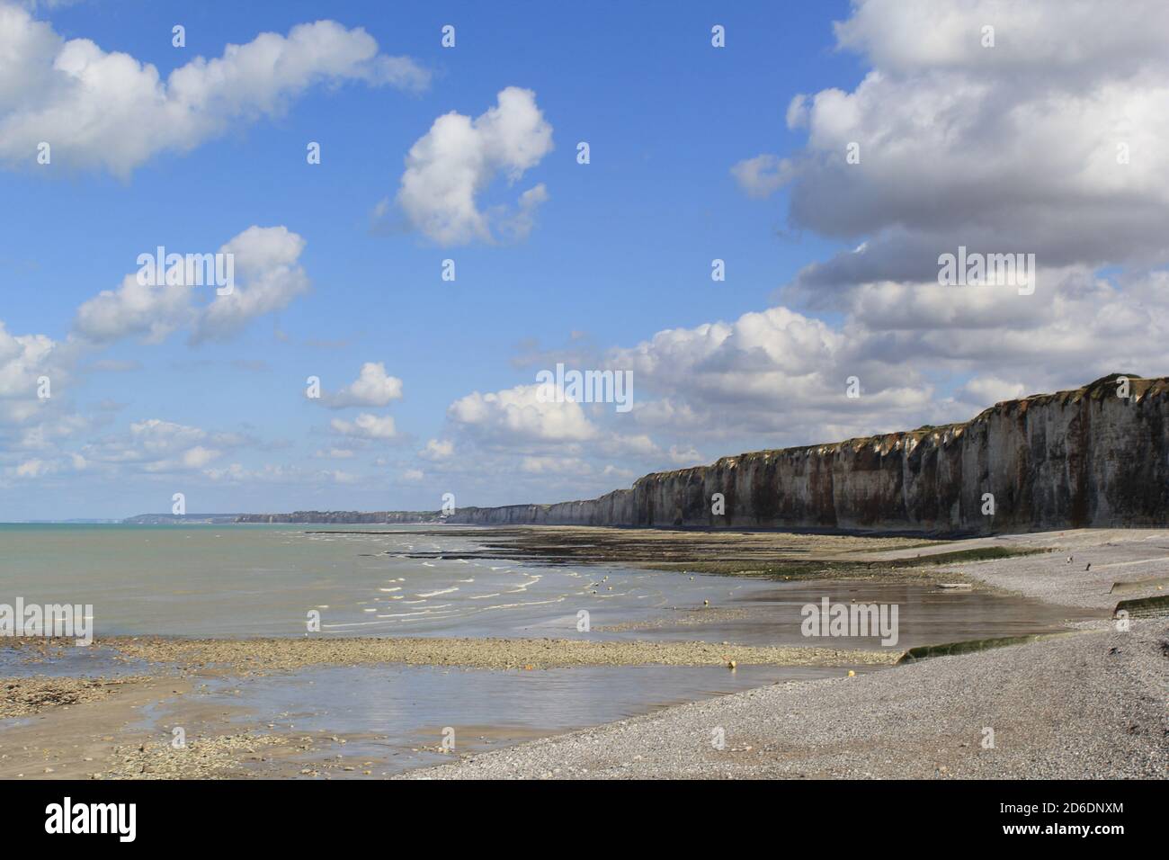 the white alabaster cliff coast in normandy in summer along the sea and ...