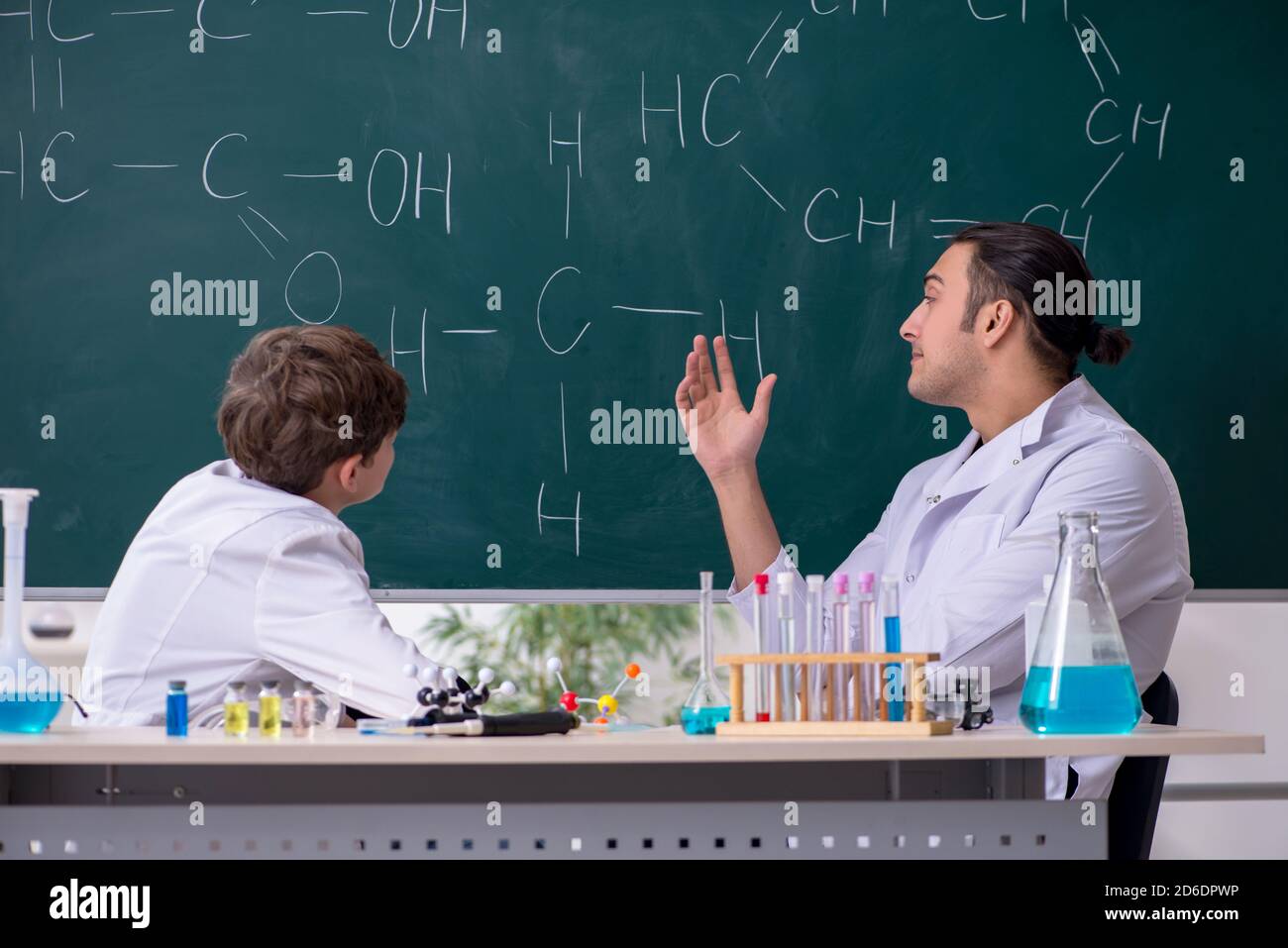 Young chemistry teacher and schoolboy in classroom Stock Photo - Alamy