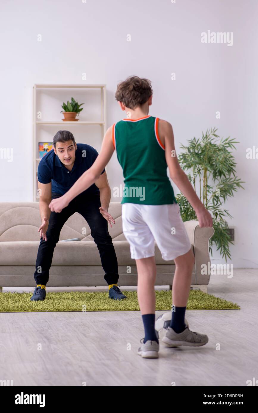 Father and son doing sport exercises at home Stock Photo - Alamy